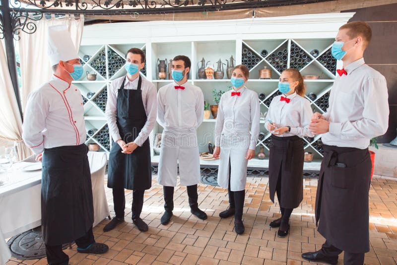 A Team of Waiters Conduct a Briefing on the Summer Terrace of the ...