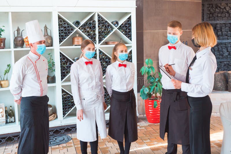 A Team of Waiters Conduct a Briefing on the Summer Terrace of the ...