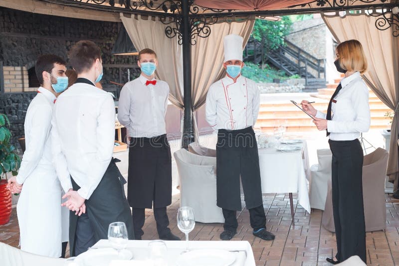 A Team of Waiters Conduct a Briefing on the Summer Terrace of the ...