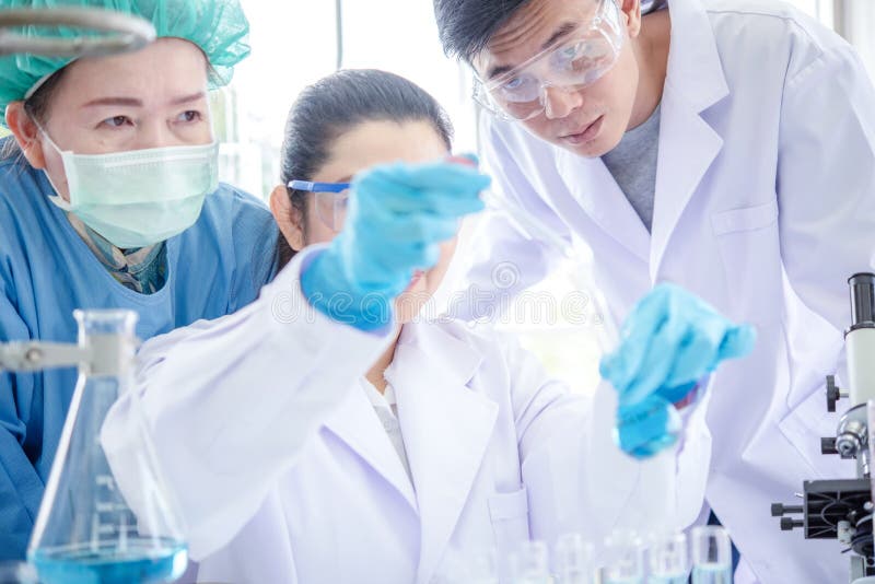 Scientists Analyzing Study Data and Evaluating Microscope. Health Care ...