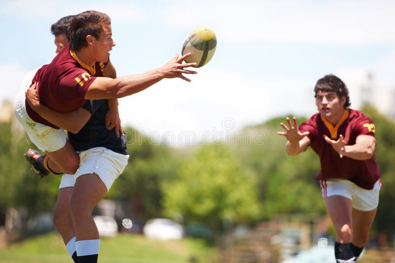 Team Work is Important To Win. a Young Rugby Player Executing a Pass ...