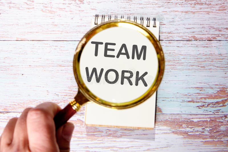 TEAM WORK Text Seen through Magnifying Glasses on a Notepad Stock Image ...
