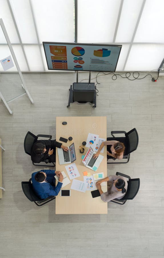 A Team of Worker is Seated Together at a Big Table in an Office ...