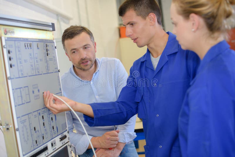 Team Workers Inserting Wire Stock Photo - Image of demonstrate, layout ...