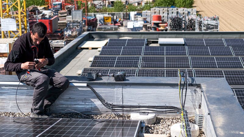 Team of Workers Preparing Electrical Connection Cables for Solar Panels ...