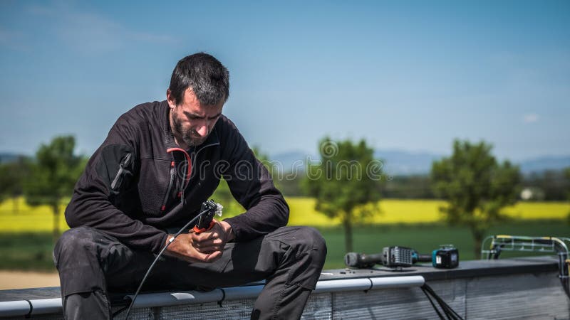 Team of Workers Preparing Electrical Connection Cables for Solar Panels ...