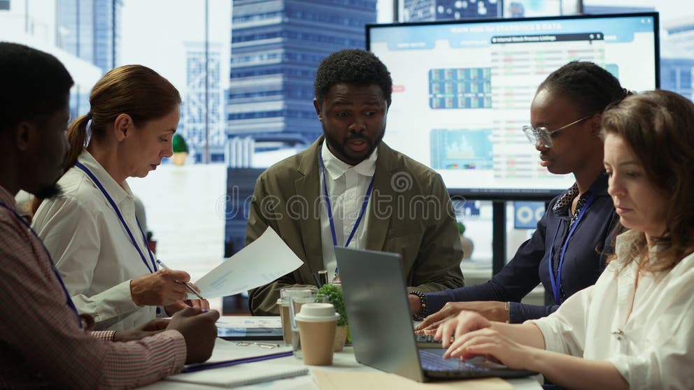 Team of Workers Presenting Infographics and Sales Numbers on ...