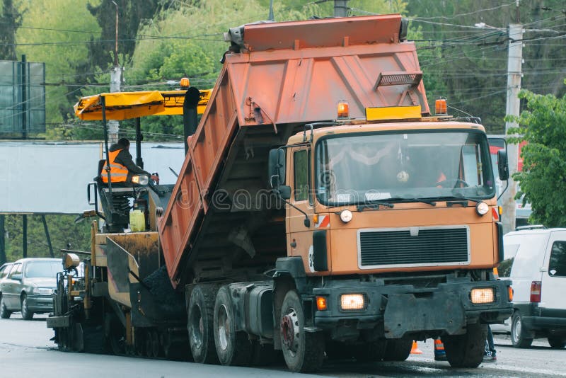 Team of Workers in Protective Uniforms Work on Road Construction. Road ...