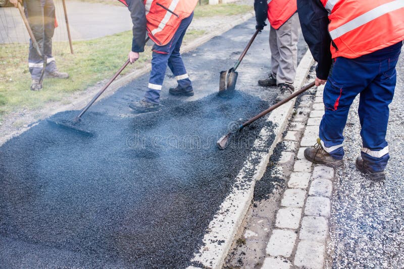 Team of Public Works Workers Redoing the Bitumen on a Sidewalk Stock ...