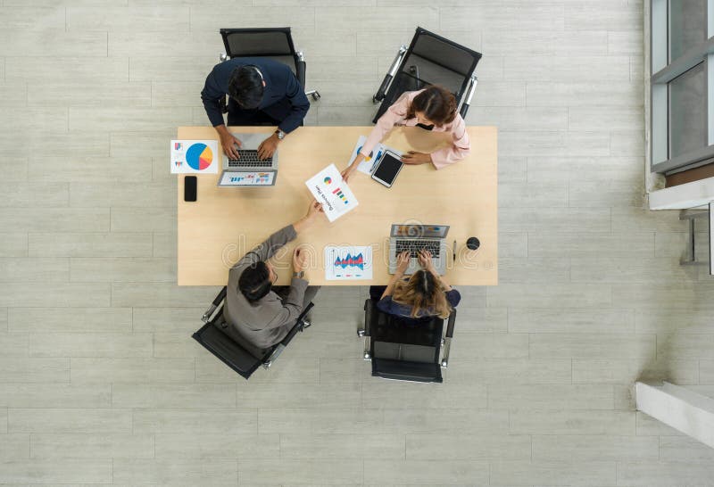 A Team of Workers is Seated Together at a Big Table in an Office ...