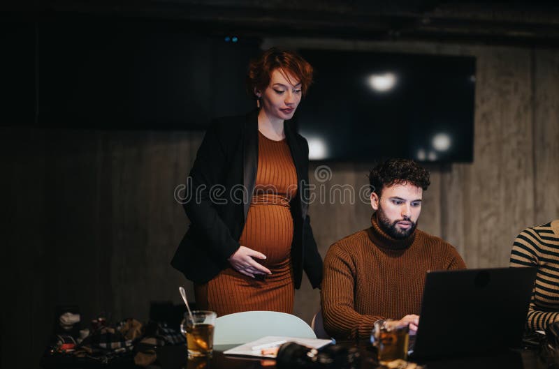 A Team of Young Business People Working Late in a Corporate Office ...