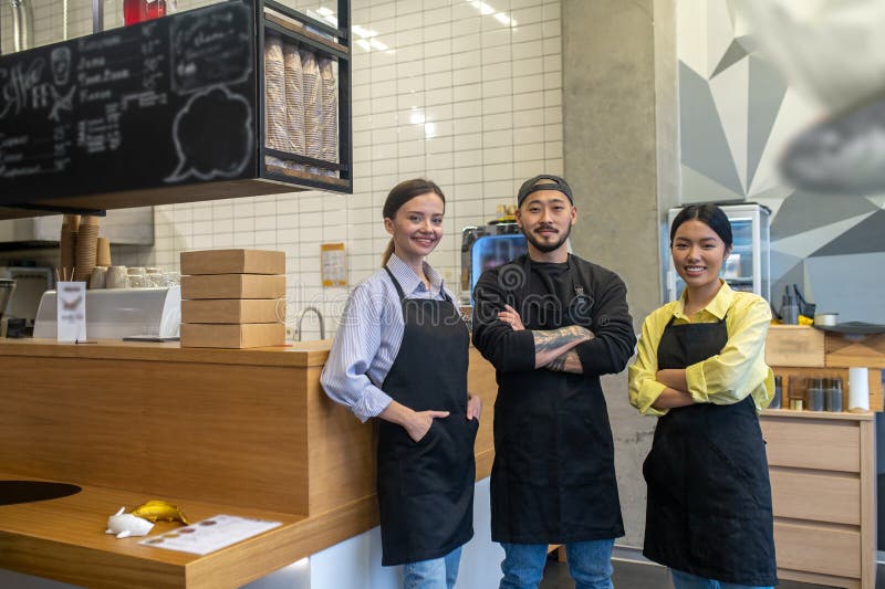 Team of Young Cafe Workers Standing Together and Looking Contented ...