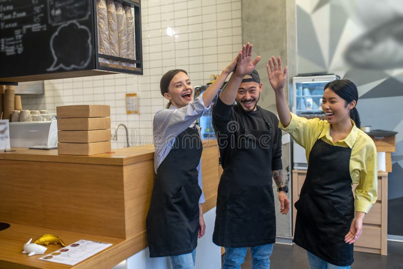 Team of Young Cafe Workers Standing Together and Looking Contented ...