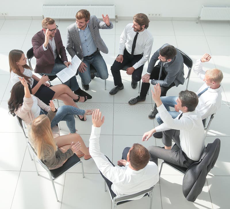 Team of Young Employees Sitting in a Circle in the Conference Room ...