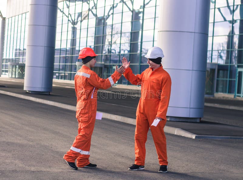 Team of Young Engineers Giving High Five after Work. Stock Image ...