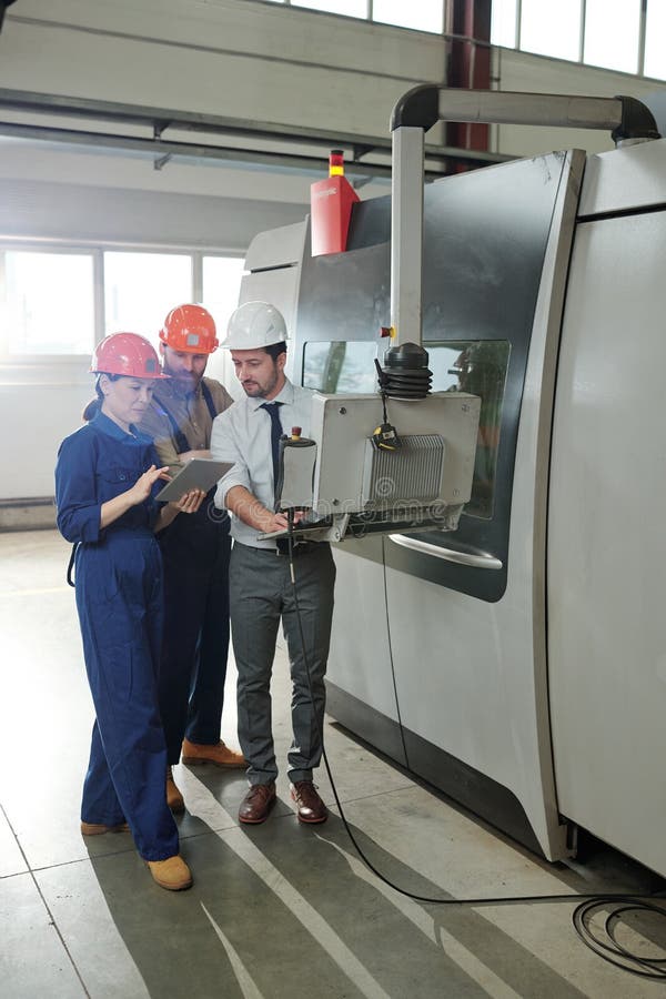 Team of Young Engineers in Workwear Working by Control Panel in ...