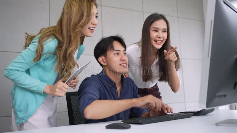 A Team of Young Multinational Business People Using Computer and ...