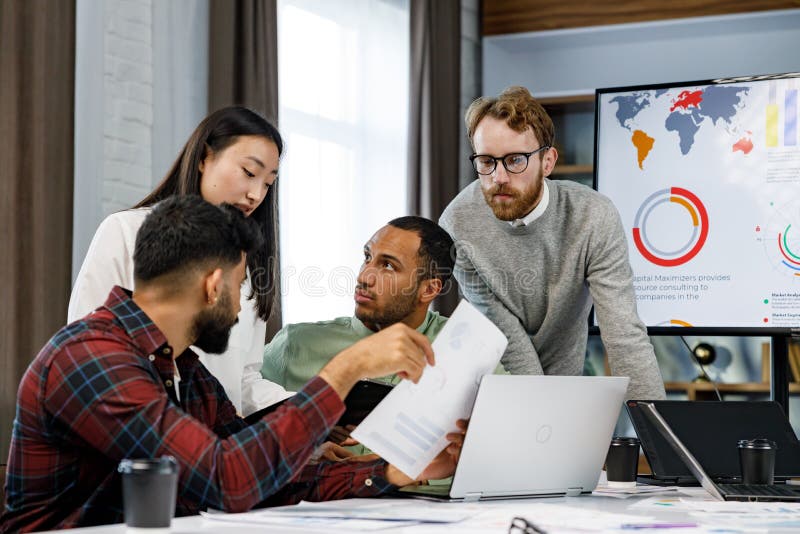 A Team of Young Multinational Business People are Working on a Startup ...