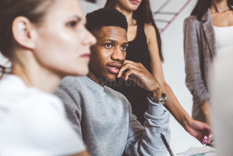 A Team of Young Office Workers, Businessmen with Laptop Working at the ...