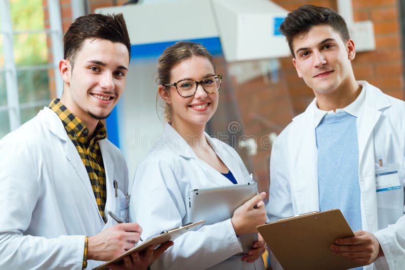 Team of Young Professional Scientists Looking at Camera in Labor Stock ...