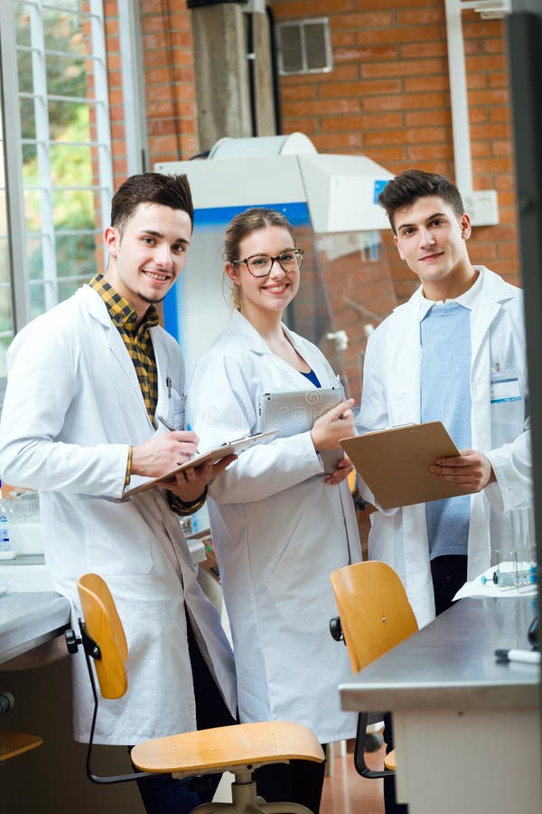 Team of Young Professional Scientists Looking at Camera in Labor Stock ...