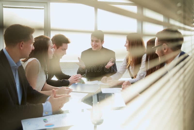 Team of Young Professionals Sitting at an Office Desk. Stock Image ...