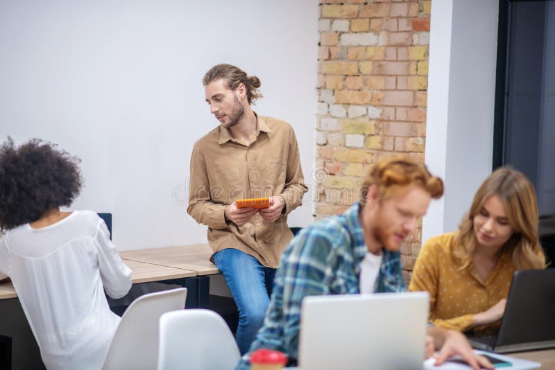 Team of Young Professionals Working in the Office Together and Looking ...