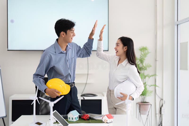 Teamwork and Achievement. Two Engineers Celebrating Their Successful ...