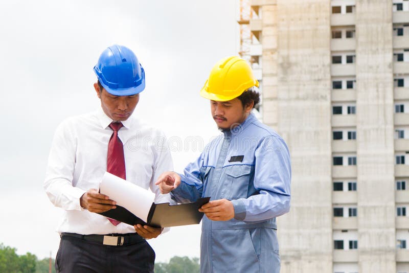Teamwork of Asian Builder Concept. Contractor and Engineer Discussing ...