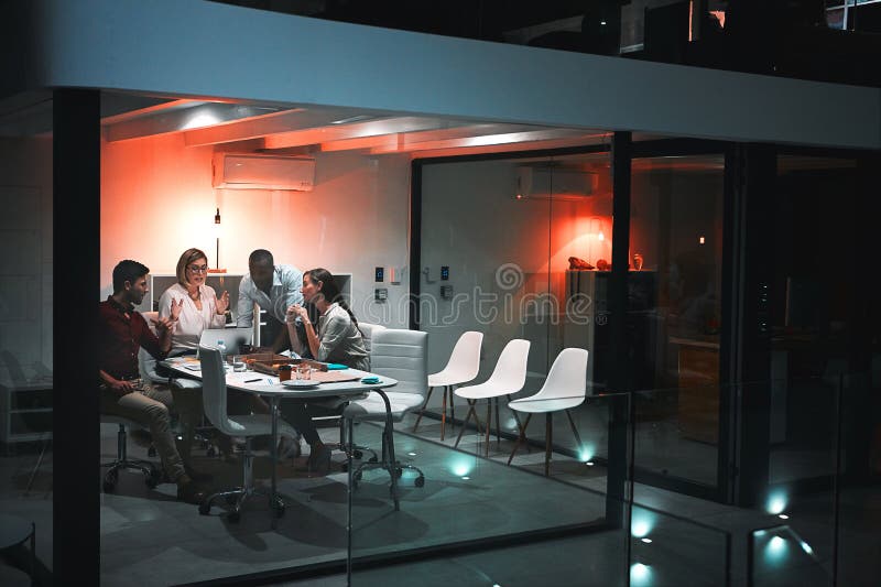 Teamwork at Its Best. Employees Working in an Office at Night. Stock ...