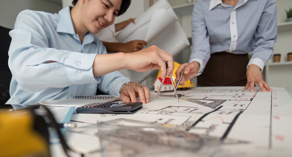 Teamwork and Blueprint Analysis. a Focused Architect Using a Compass To ...