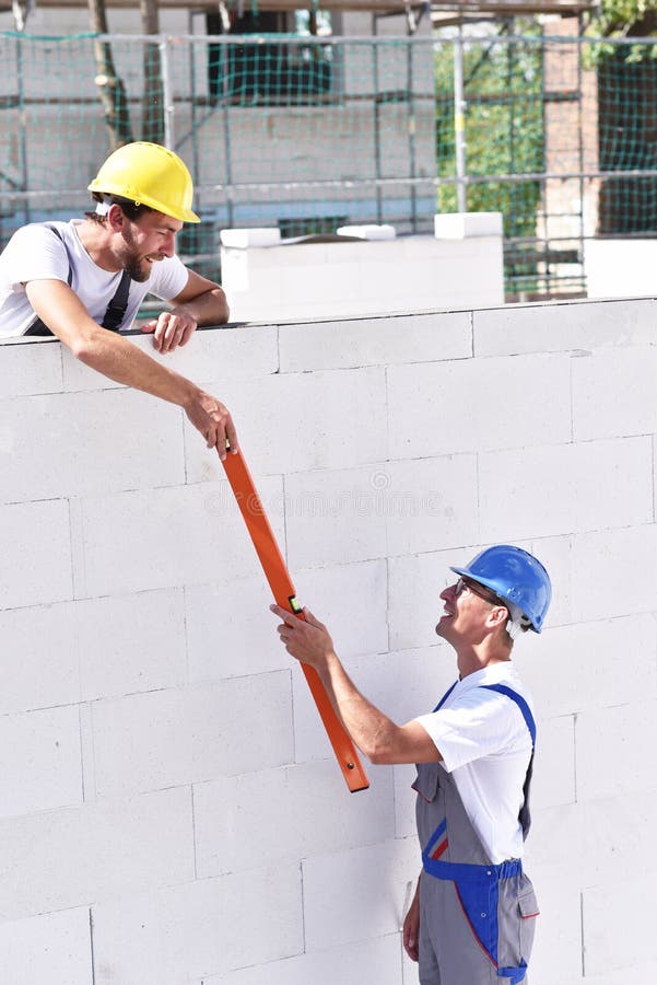 Teamwork on the Building Site - Construction Workers Build a Family ...