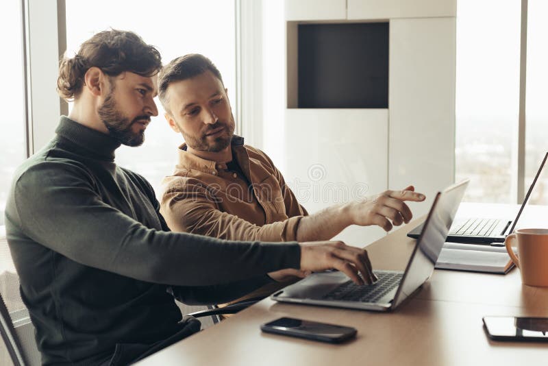 Teamwork and Collaboration. Male Coworkers Communicating, Using Laptop ...