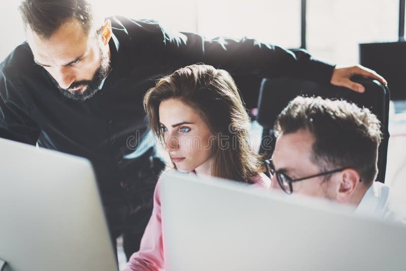 Group of Three Coworkers Working Together on Business Project in Modern ...