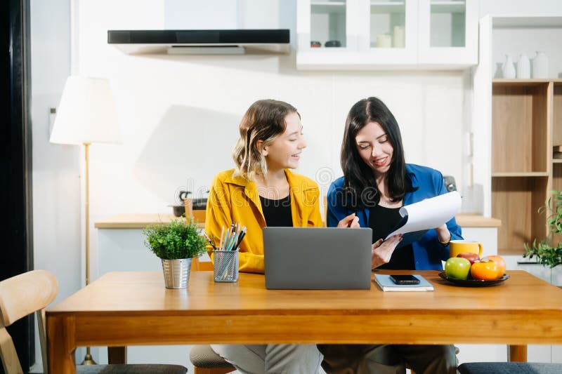 Teamwork and Creativity with Young Adults Collaborating on Laptops and ...