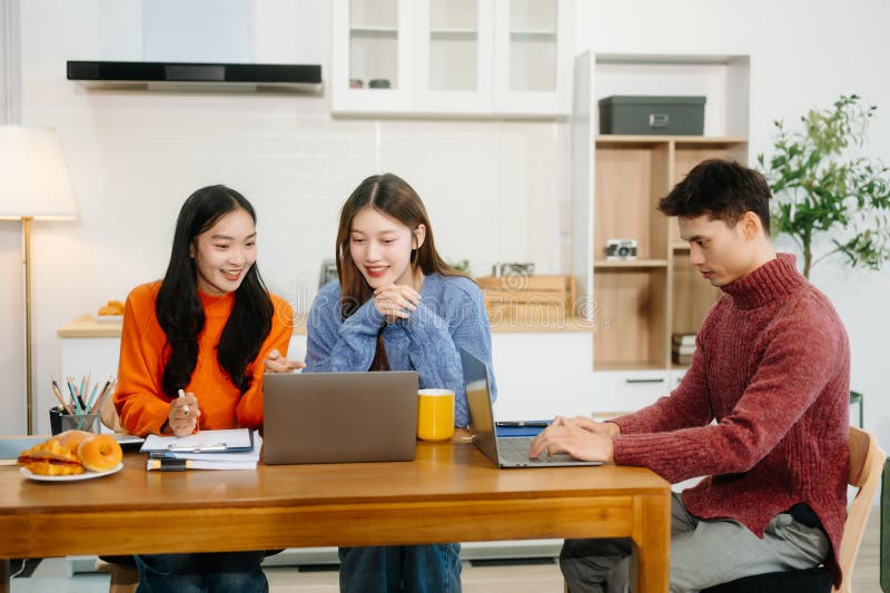 Teamwork and Creativity with Young Adults Collaborating on Laptops and ...