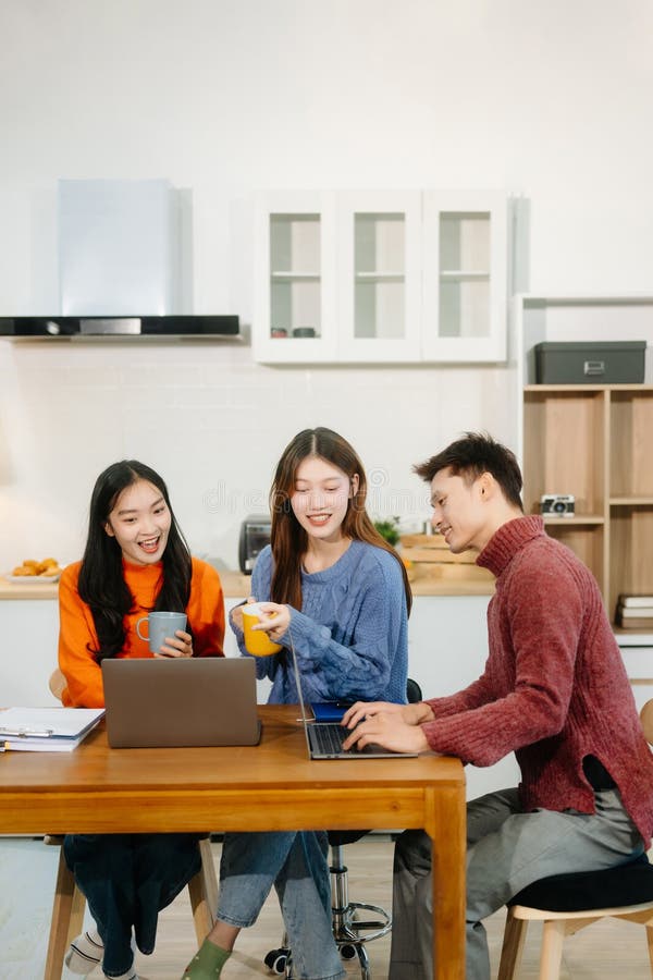 Teamwork and Creativity with Young Adults Collaborating on Laptops and ...