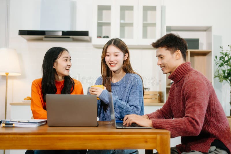 Teamwork and Creativity with Young Adults Collaborating on Laptops and ...