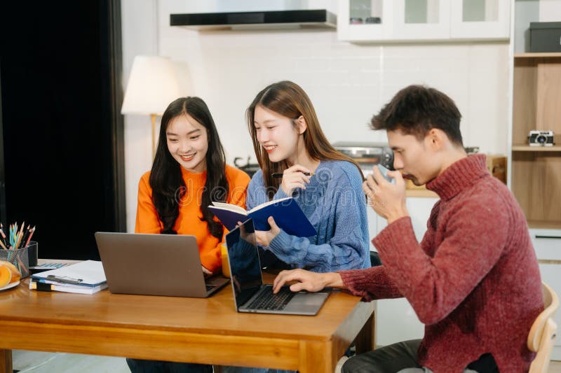 Teamwork and Creativity with Young Adults Collaborating on Laptops and ...