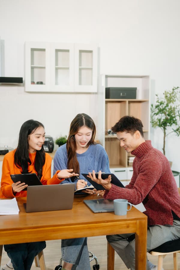 Teamwork and Creativity with Young Adults Collaborating on Laptops and ...