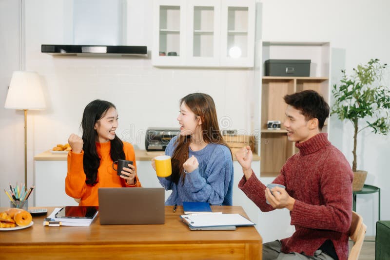 Teamwork and Creativity with Young Adults Collaborating on Laptops and ...