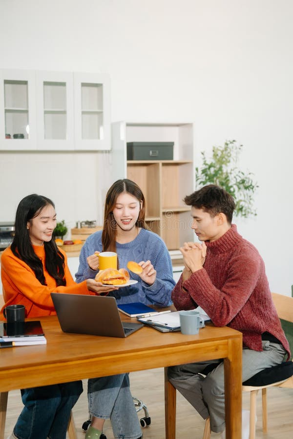 Teamwork and Creativity with Young Adults Collaborating on Laptops and ...