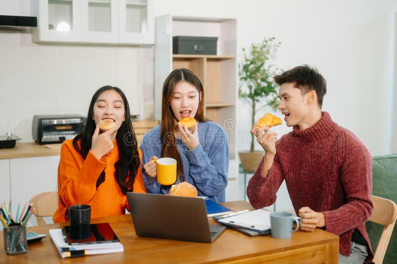 Teamwork and Creativity with Young Adults Collaborating on Laptops and ...