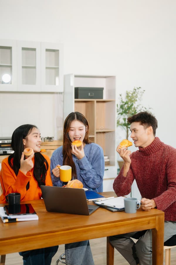 Teamwork and Creativity with Young Adults Collaborating on Laptops and ...