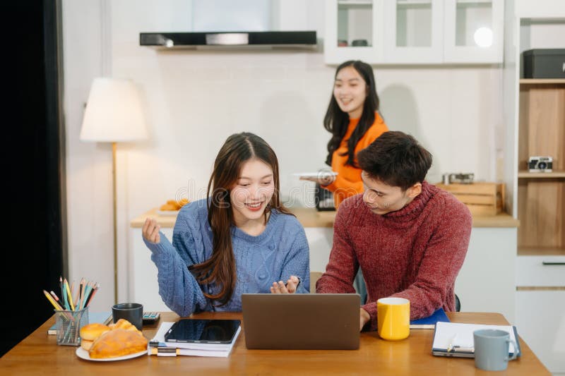 Teamwork and Creativity with Young Adults Collaborating on Laptops and ...