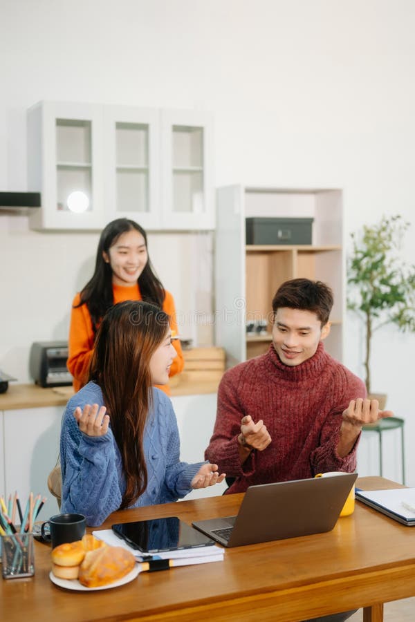 Teamwork and Creativity with Young Adults Collaborating on Laptops and ...