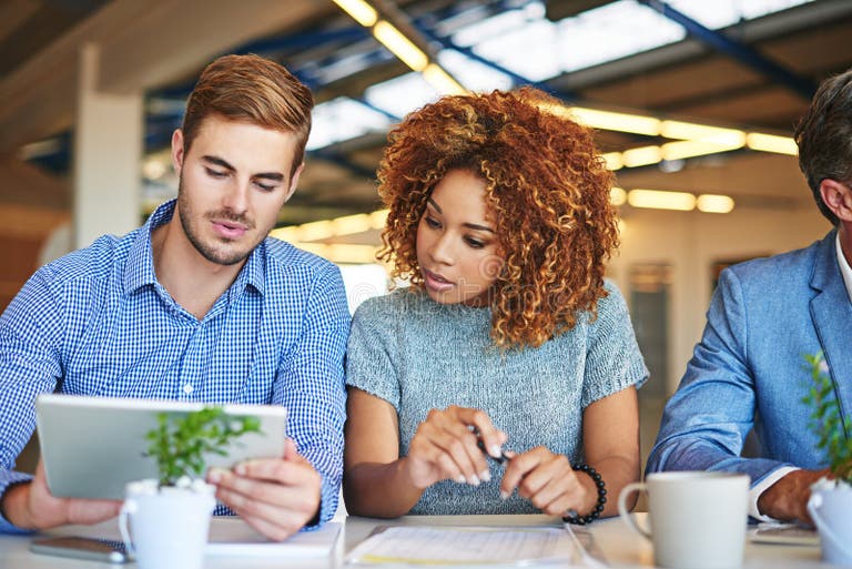 Teamwork in Focused on Their Digital Workflow. Smiling Colleagues ...