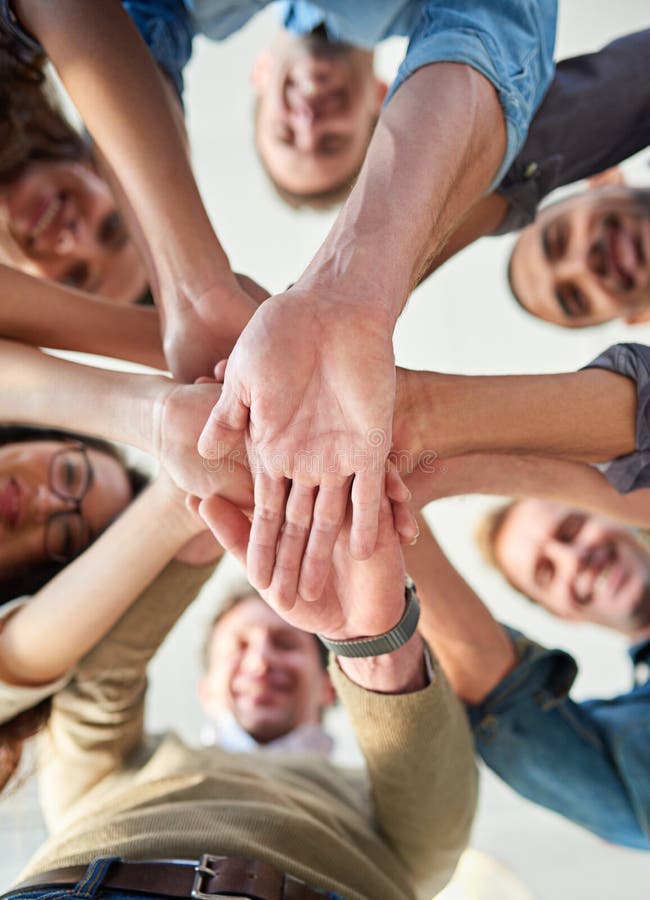 Teamwork Gets the Job Done. Low Angle Shot of a Group of Co-workers ...