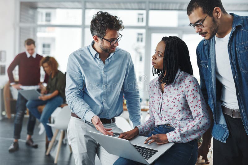 Teamwork Gets Business Done. a Group of Businesspeople Going Over Some ...