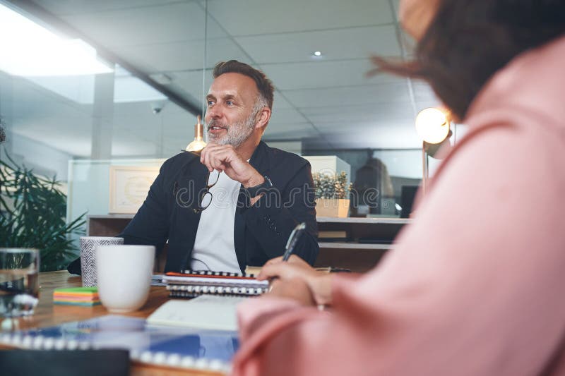 Teamwork Gets the Task Done. a Team of Businesspeople Having a Meeting ...